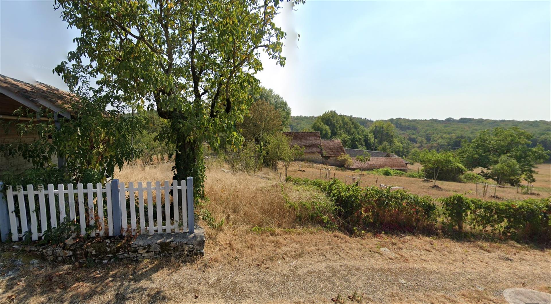 Serviced building land with small building