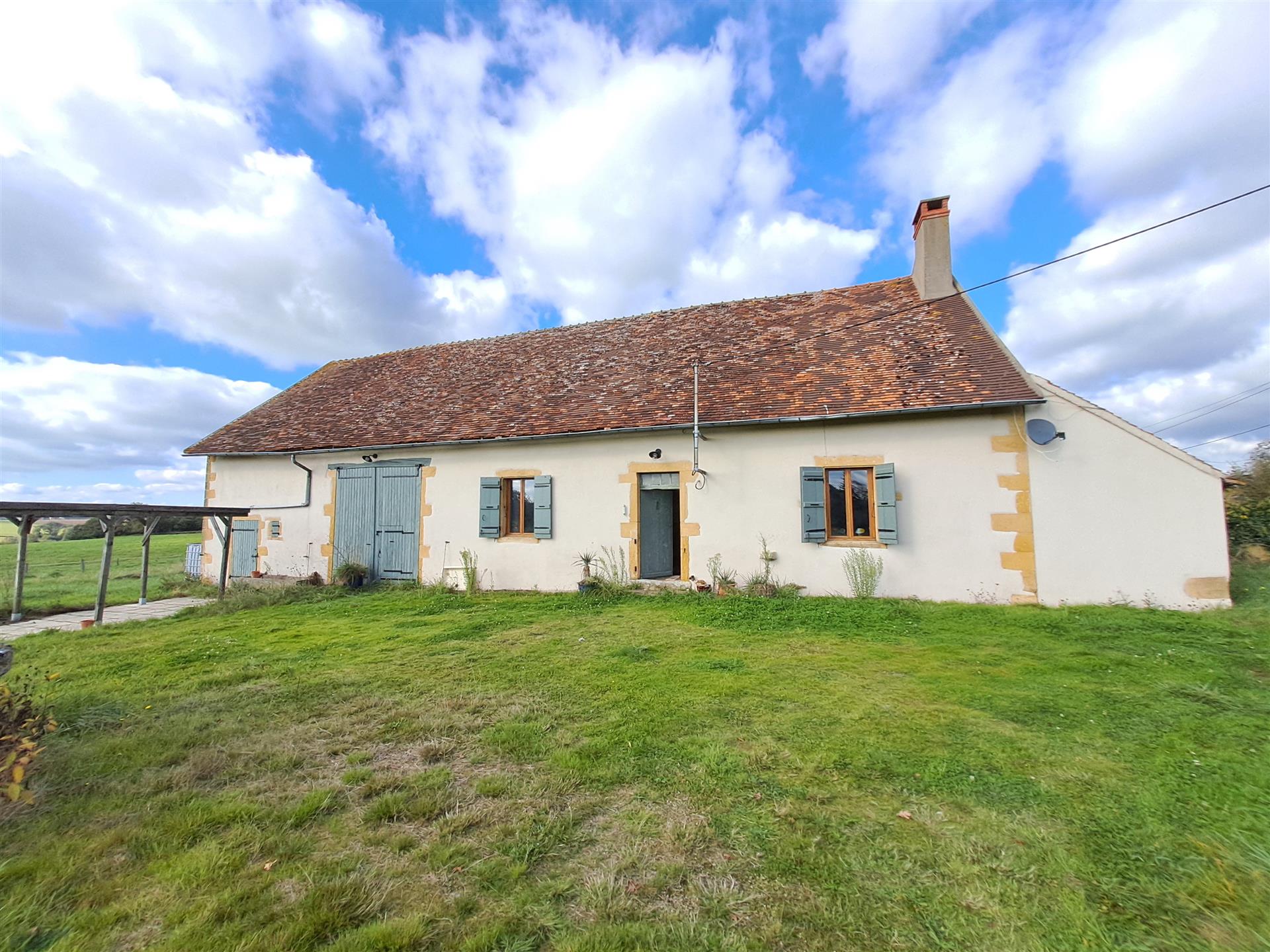Beautiful old farmhouse with barn and garden in the countryside.